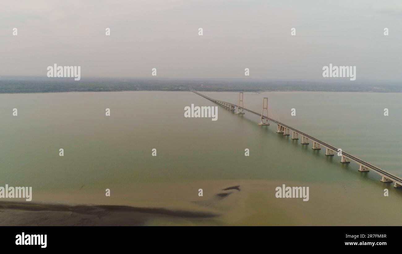 suspension bridge over madura strait with highway and car, surabaya ...