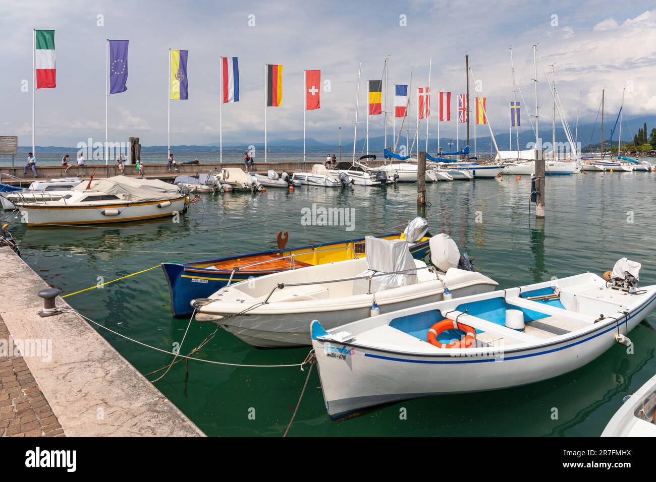 Small boats and yachts moored in the harbour at Bardolino with European ...