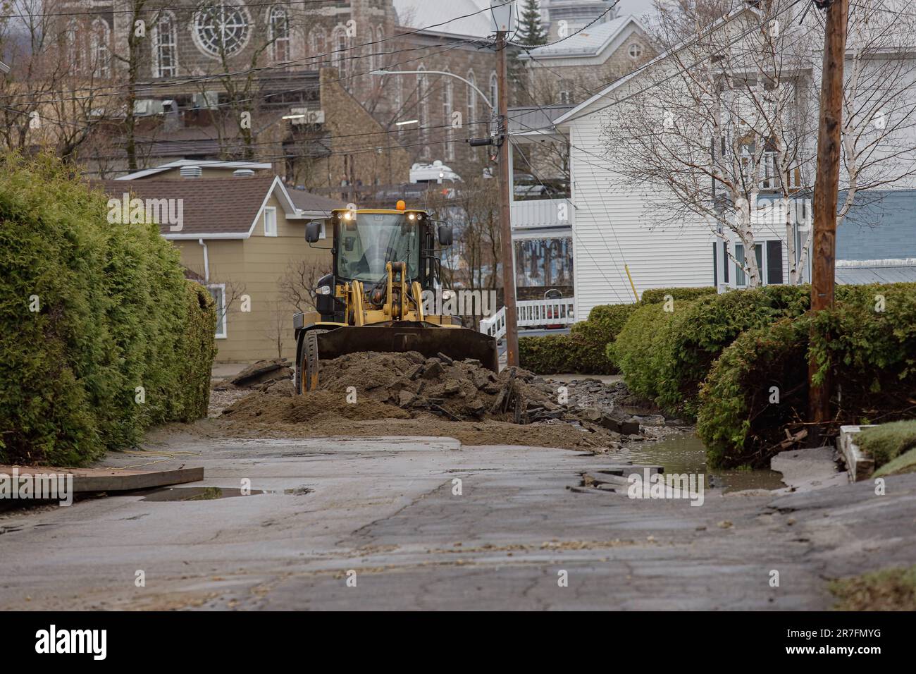 An excavator is removing the soil and mud that were deposited on Menard ...