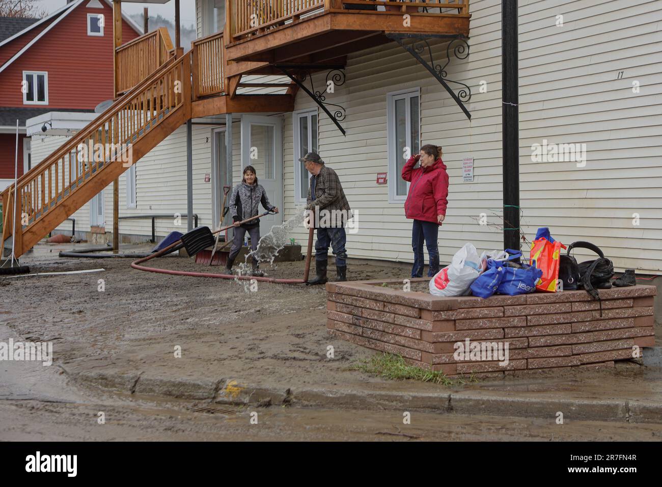 People are working on a flooded house on St-Joseph Street in Baie St ...