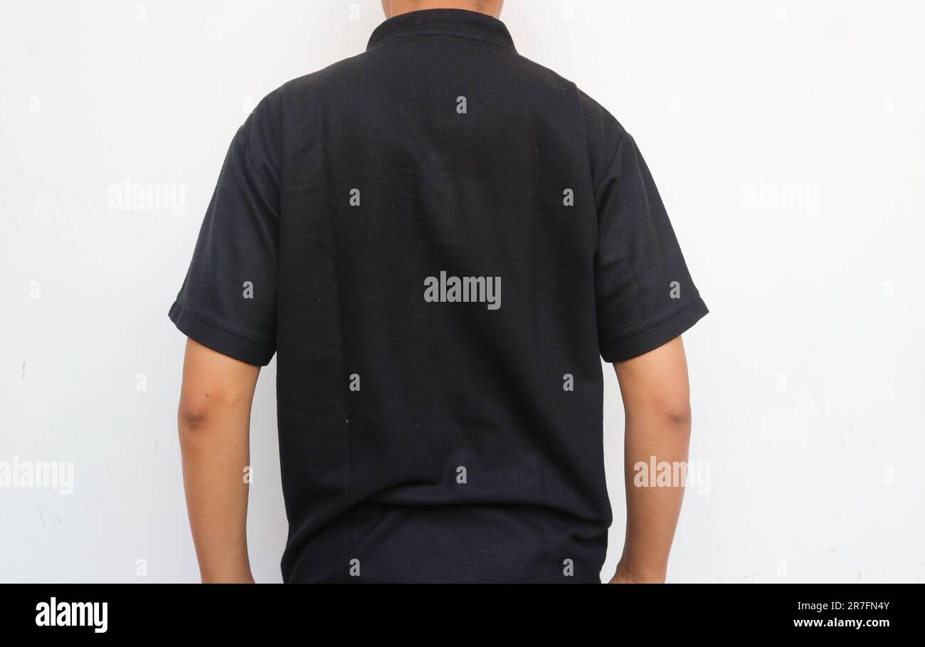 Rear view of a man in a black t-shirt backwards looking away Stock ...