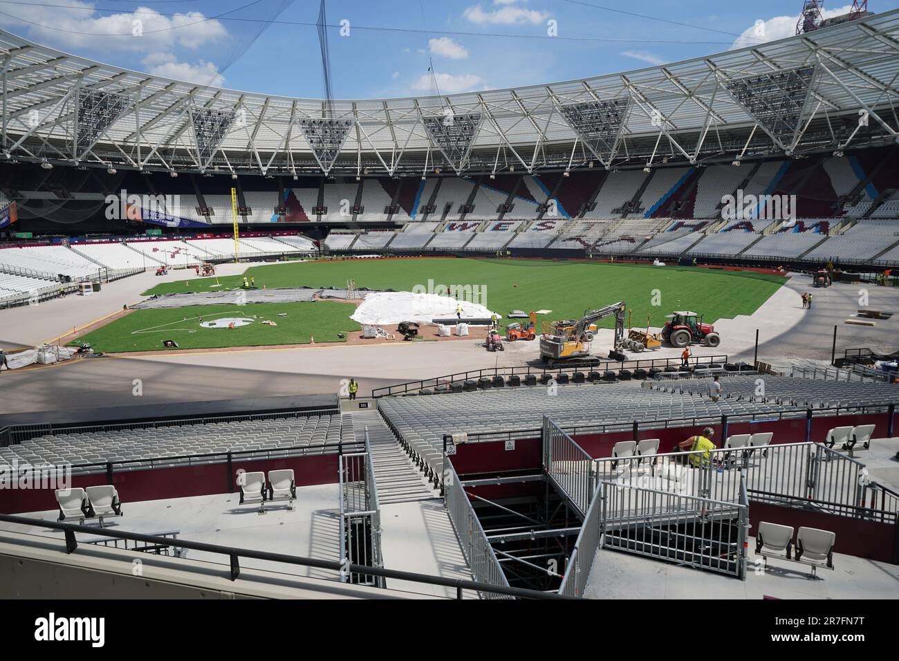 Workers transform the pitch into a baseball field at the London Stadium ...