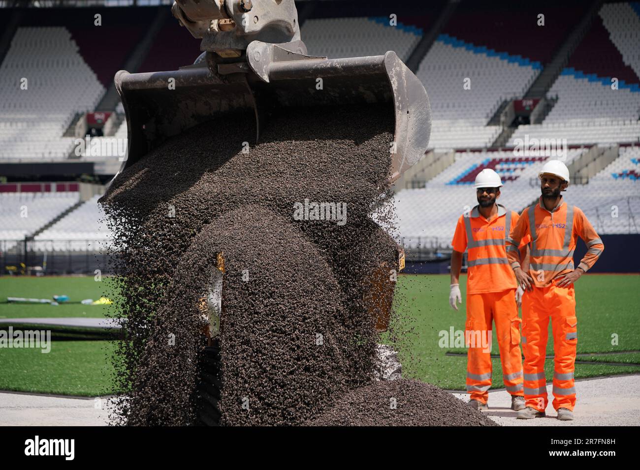 Workers transform the pitch into a baseball field at the London Stadium ...