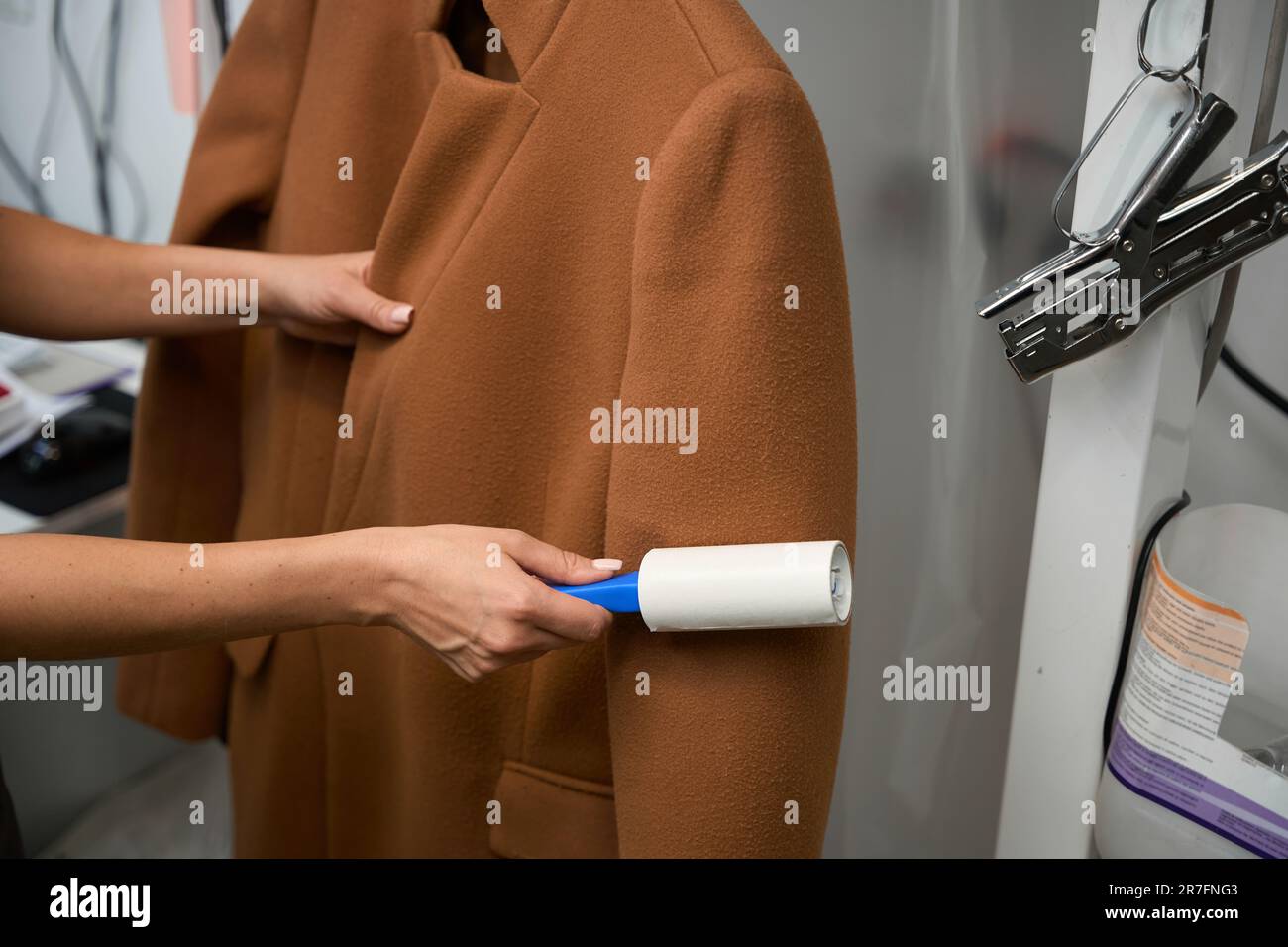 Woman cleaning lint from hi-res stock photography and images - Alamy