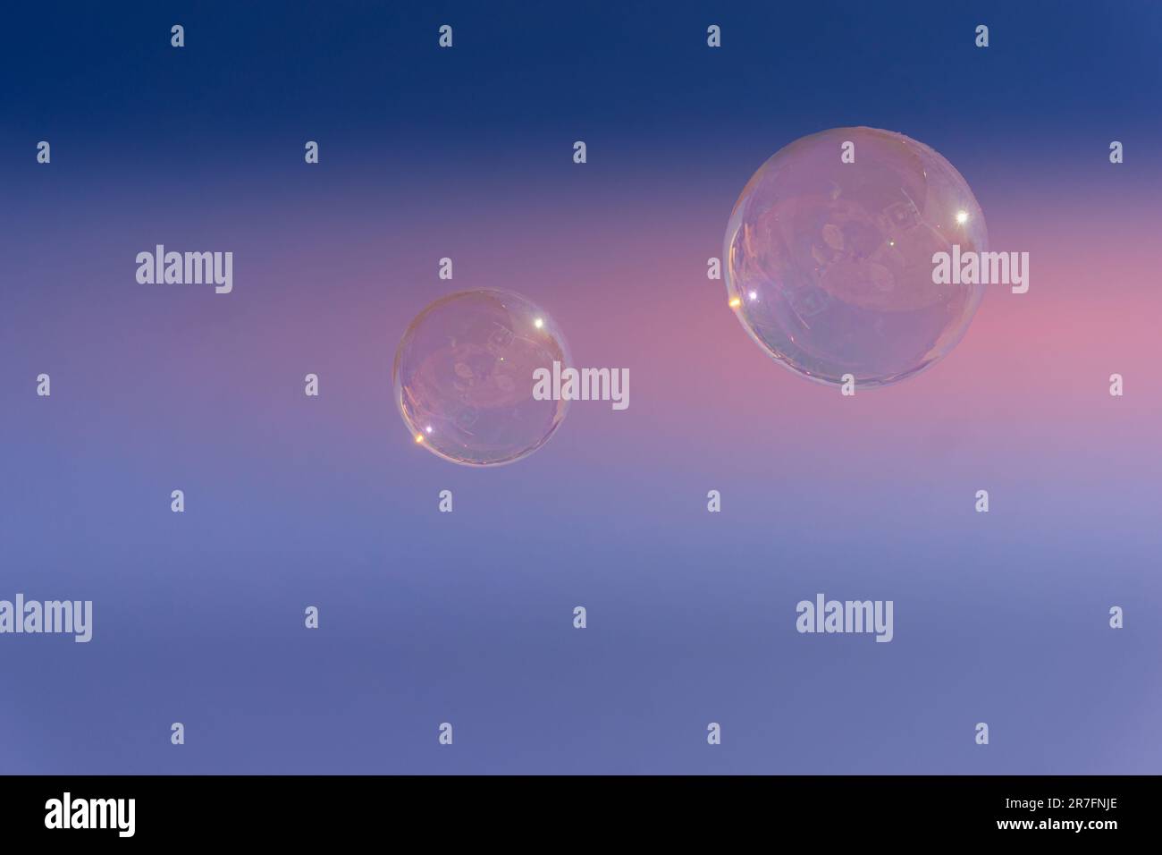 Two soap bubbles against a golden hour sky Stock Photo - Alamy