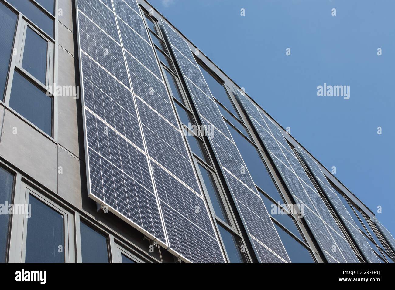 Modern building with solar panels on the wall, facade Stock Photo - Alamy