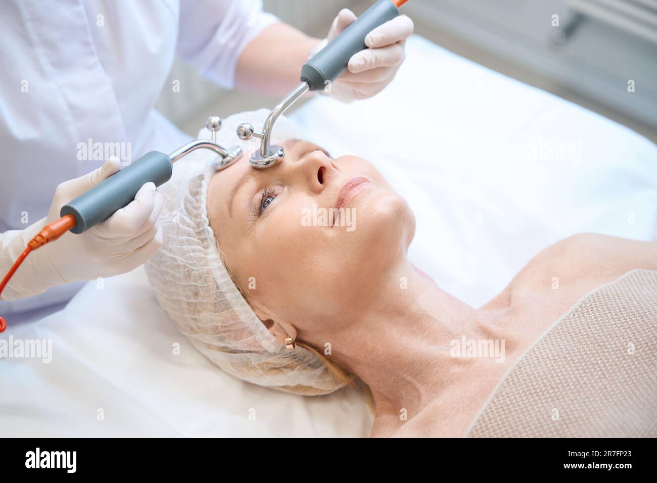 Happy adult woman getting microcurrent therapy in beauty salon Stock Photo - Alamy