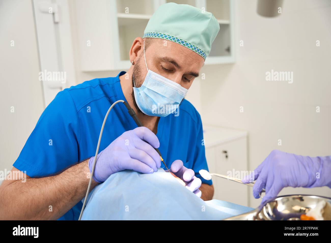 Portrait of surgeon during ear operation with radio wave knife Stock ...