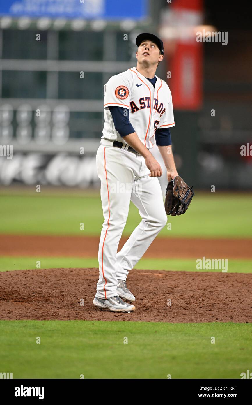 Houston Astros relief pitcher Phil Maton (88) watches a fly ball that ...