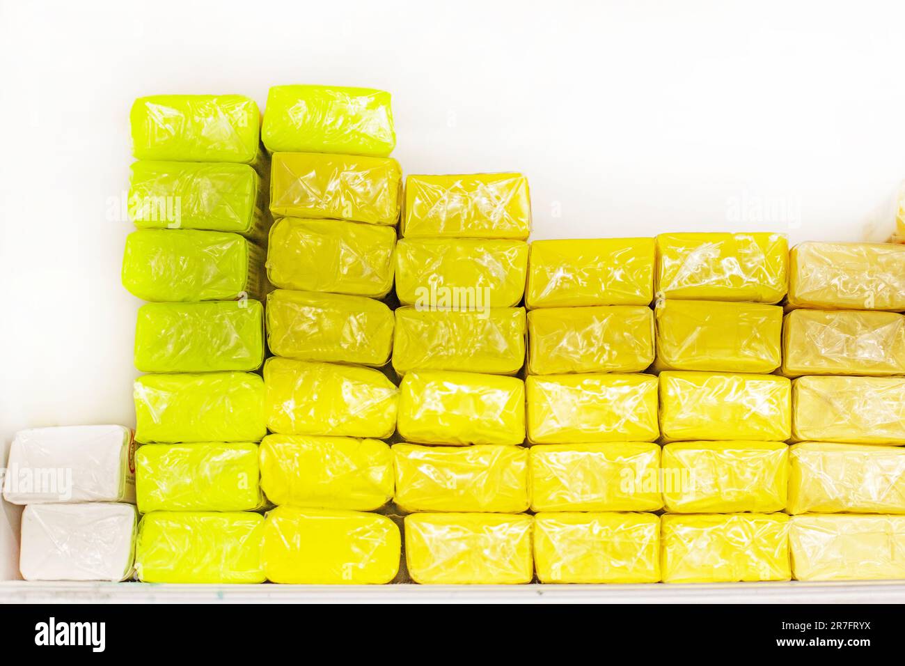 various shades of yellow soft molding mass packed in a transparent film ...