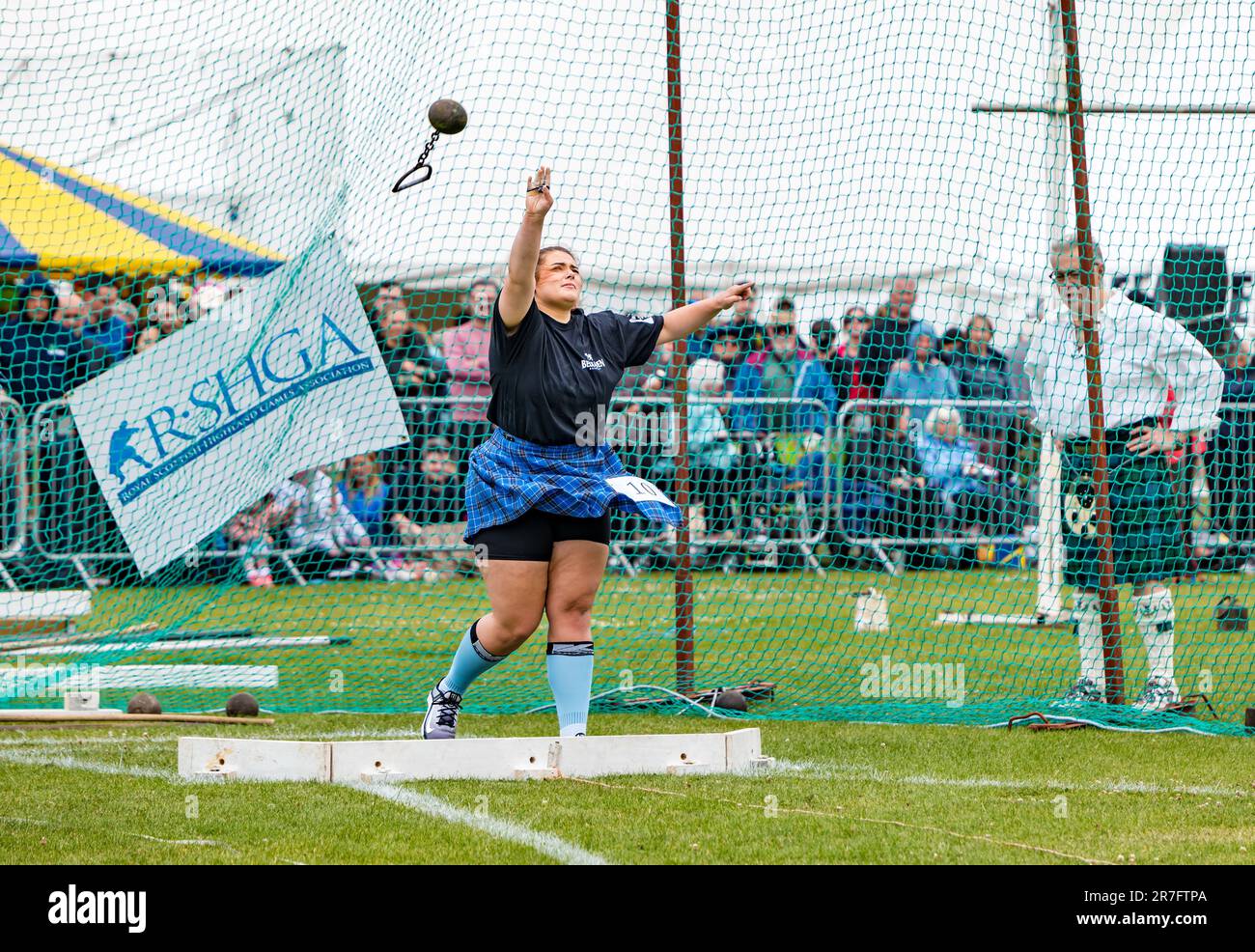 Female competittor in heavy ball and chain game event, Highland Games ...