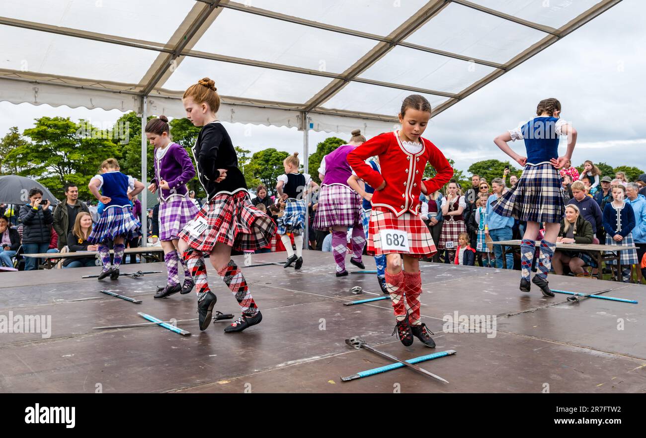 Young girls competing in highland sword dancing event wearing ...
