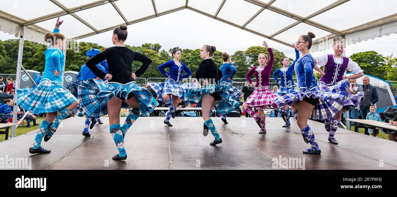 Girls competing in highland dancing event wearing traditional Scottish ...
