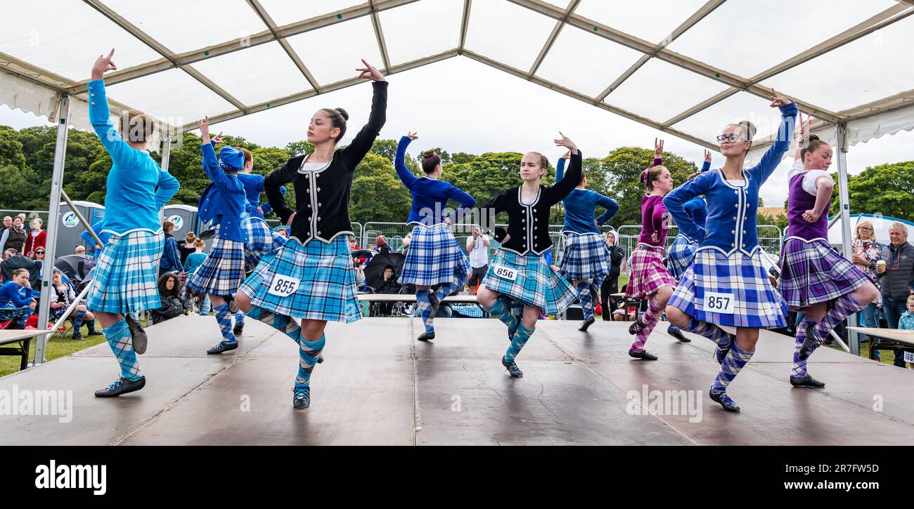 Girls competing in highland dancing event wearing traditional Scottish ...