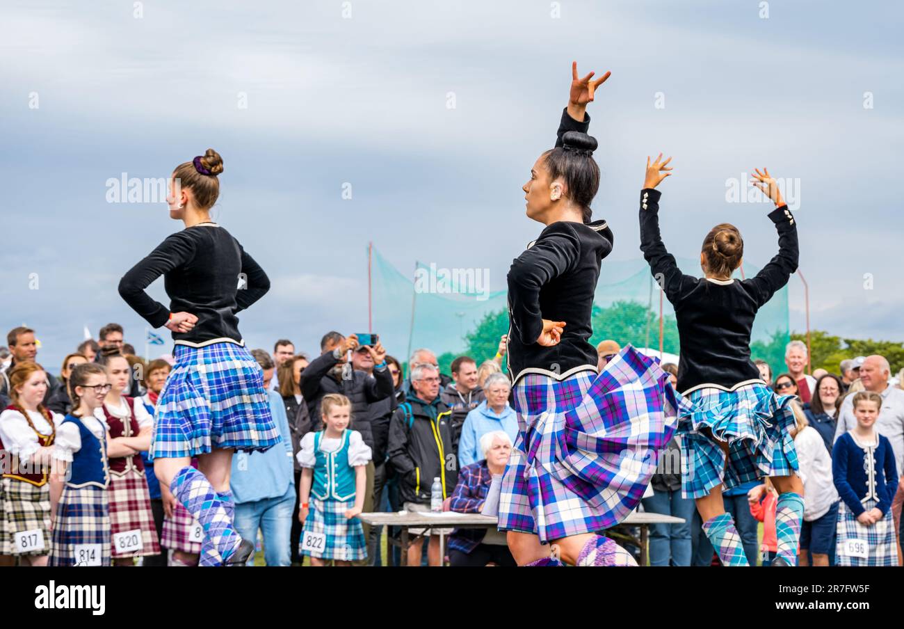 Young women competing in highland dancing event wearing traditional ...