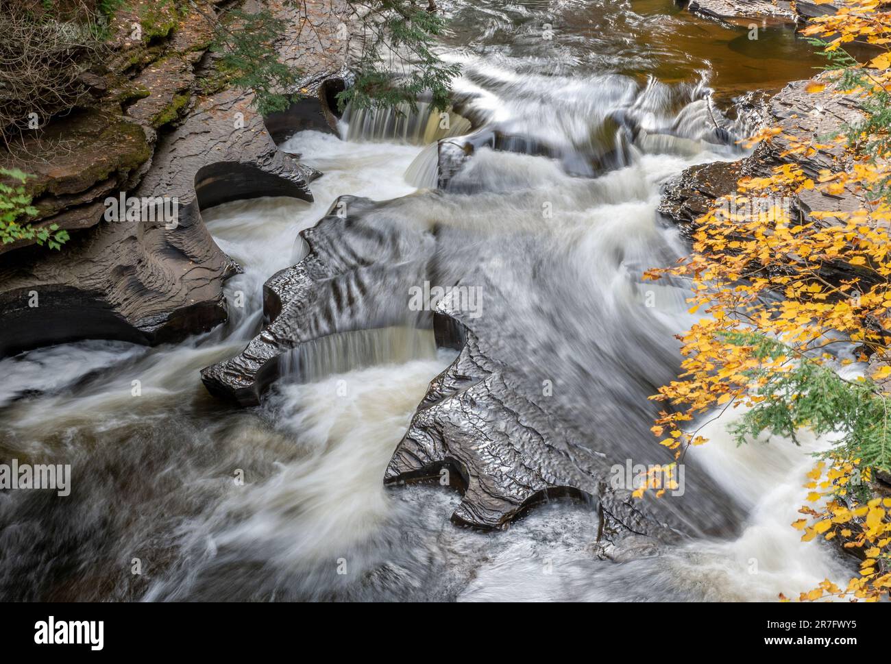 The Presque Isle River of the Upper Peninsula of Michigan is an autumn ...