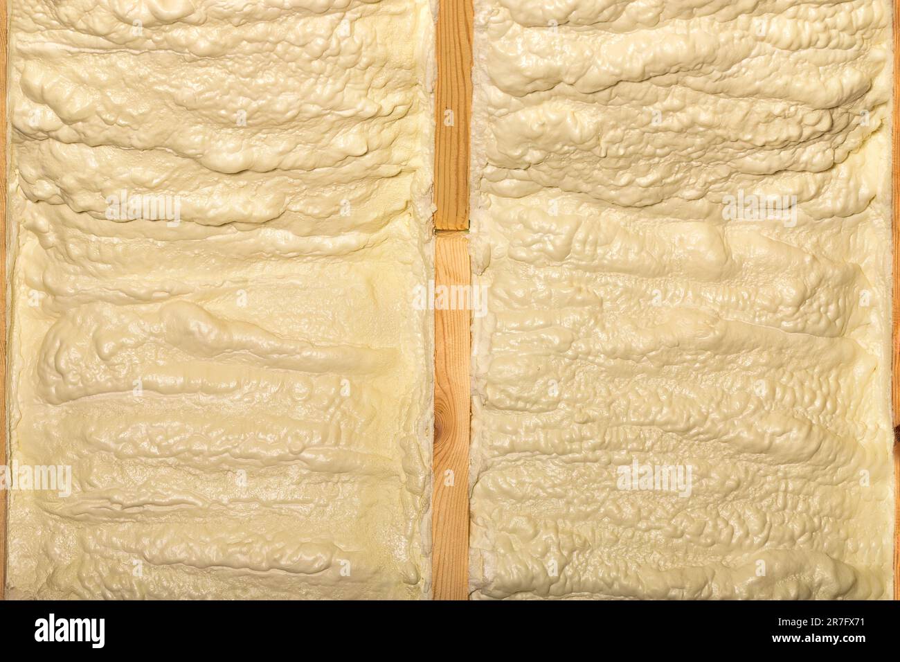 The texture of the frozen building yellow foam between the wooden ...