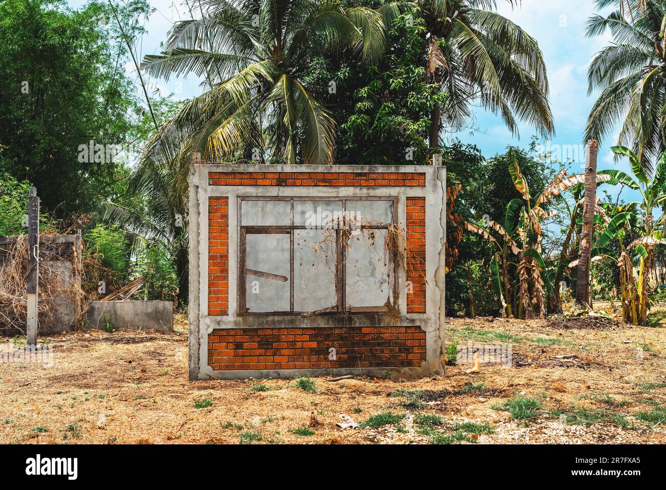 Exterior of old abandoned brick house with broken doors and windows. An ...