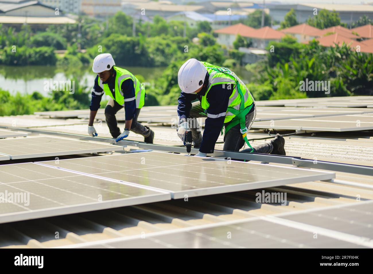 Engineers with safety helmet checking solar system at solar power farm ...