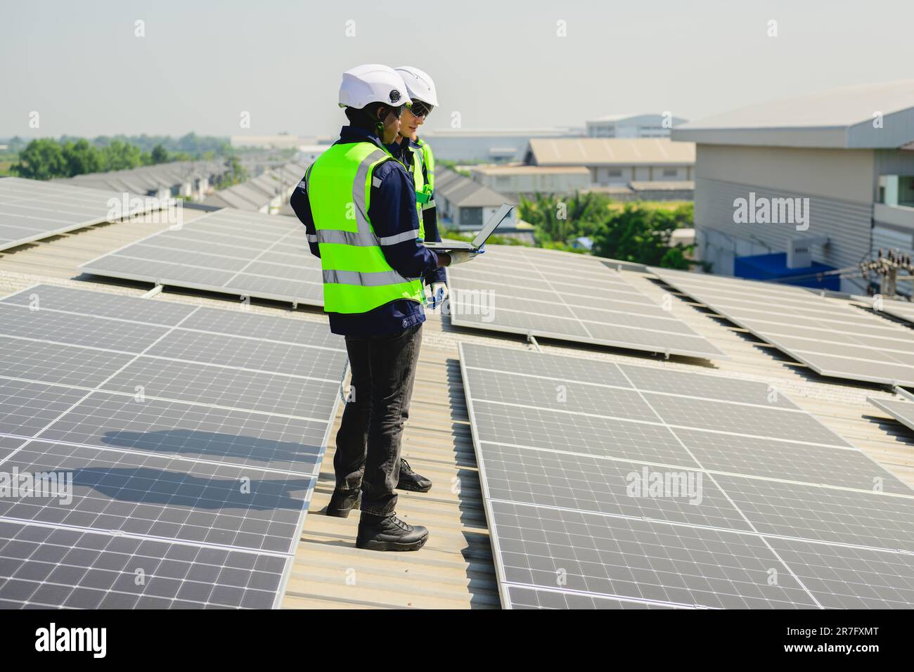 Engineers with safety helmet checking solar system at solar power farm ...