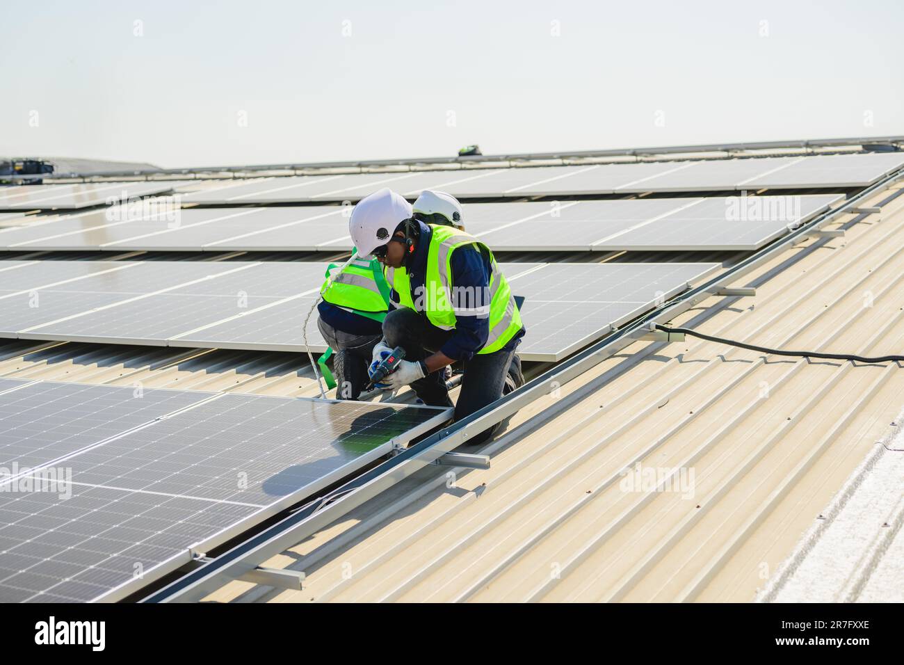 Engineers with safety helmet checking solar system at solar power farm ...
