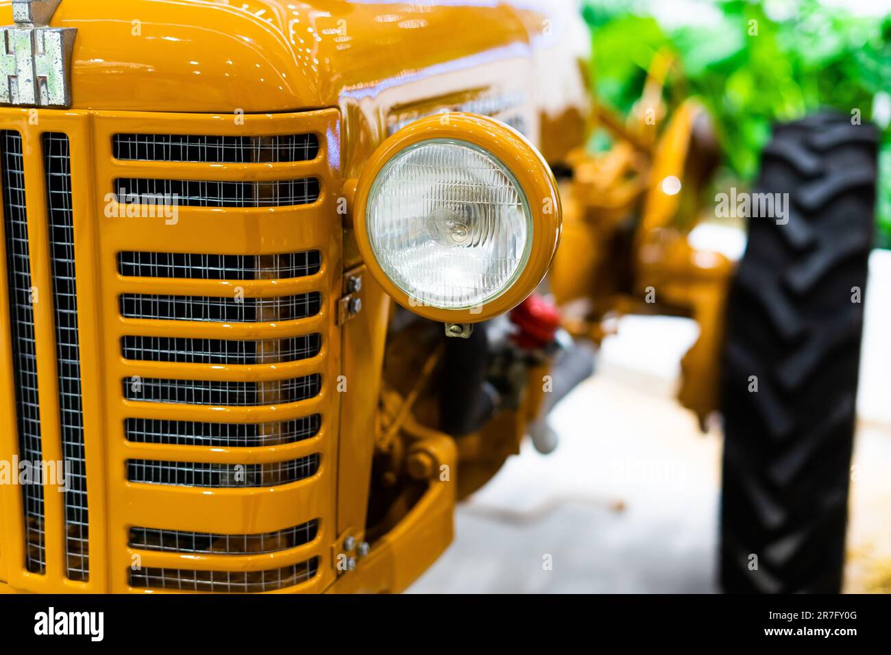 Small yellow tractor in exhibition, closeup details, wheels Stock Photo ...