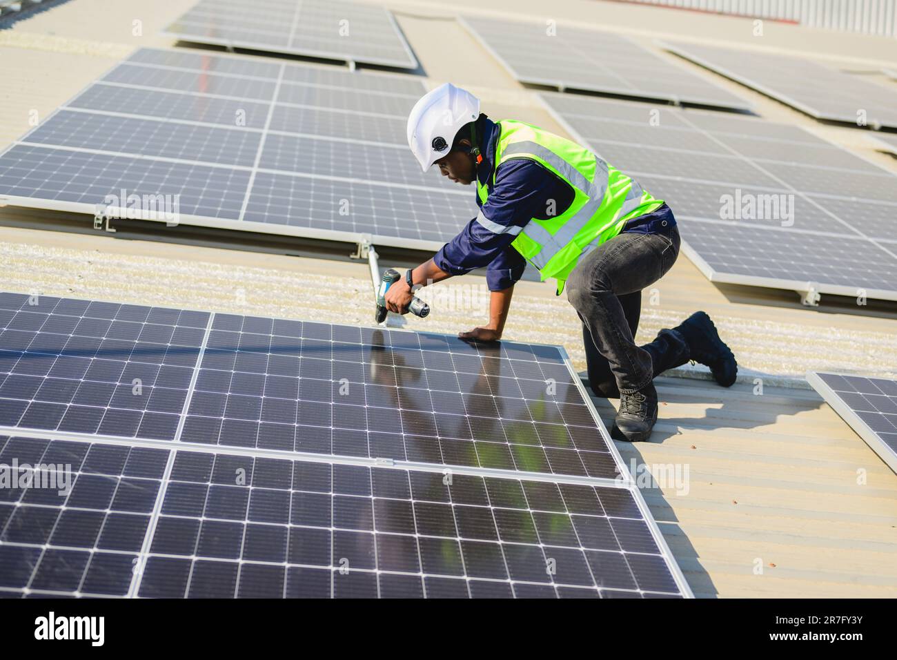 Engineers with safety helmet checking solar system at solar power farm ...