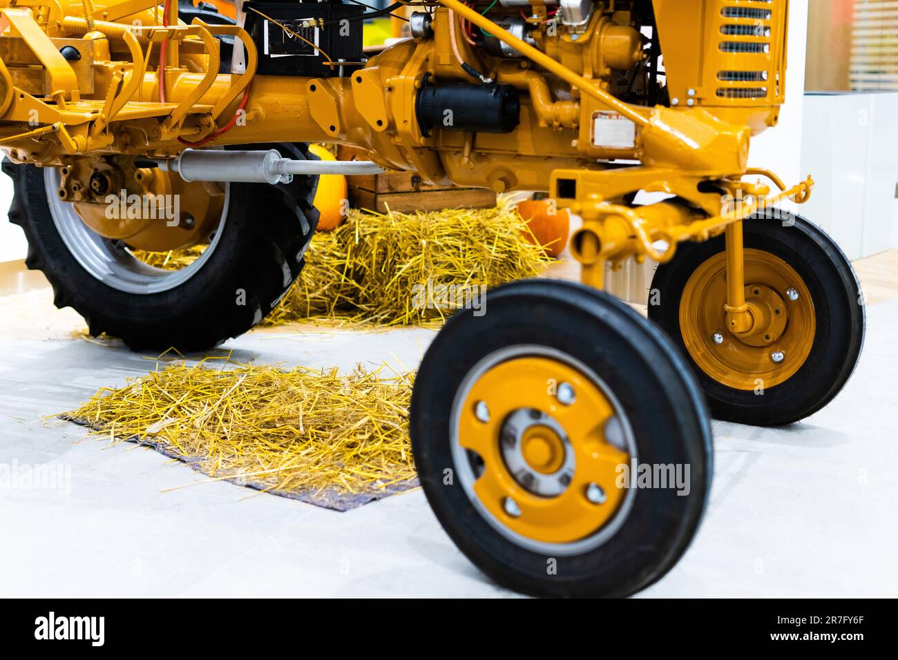Small yellow tractor in exhibition, closeup details, wheels Stock Photo ...
