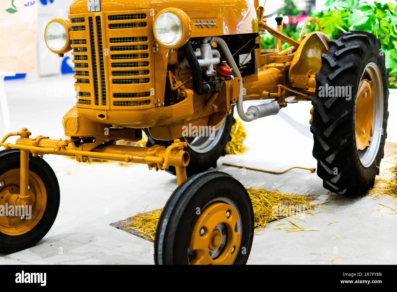 Small yellow tractor in exhibition, closeup details, wheels Stock Photo ...