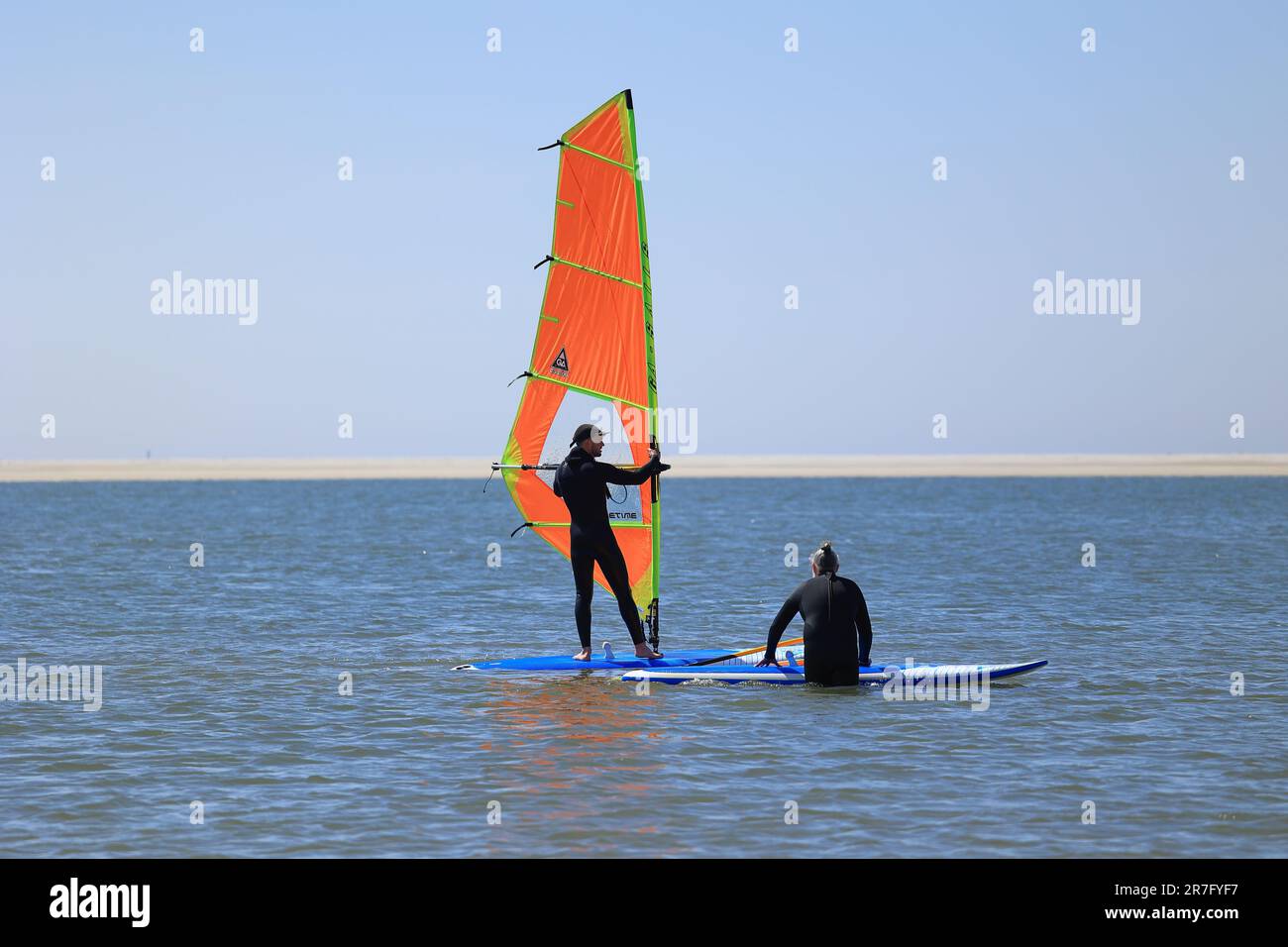 Surfers in the North Sea on the beach in Borkum Stock Photo - Alamy