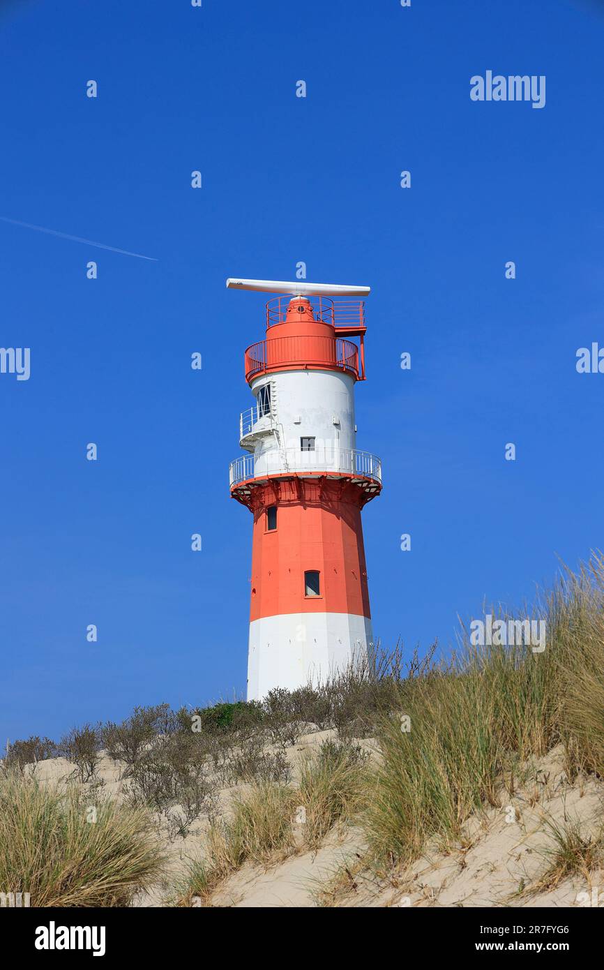 The electric lighthouse on the island of Borkum stands behind a dune ...