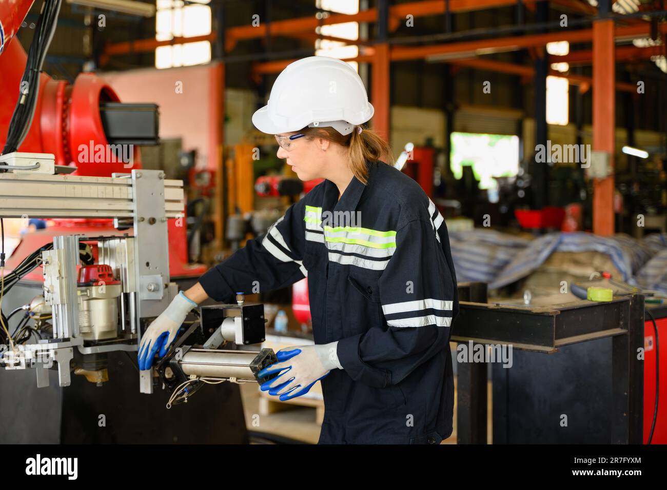 Mechanical engineers repairing engine machine at factory Stock Photo ...