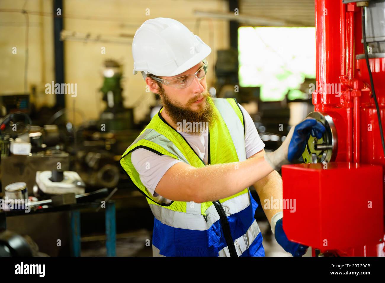 Mechanical engineer repairing engine machine at factory Stock Photo - Alamy