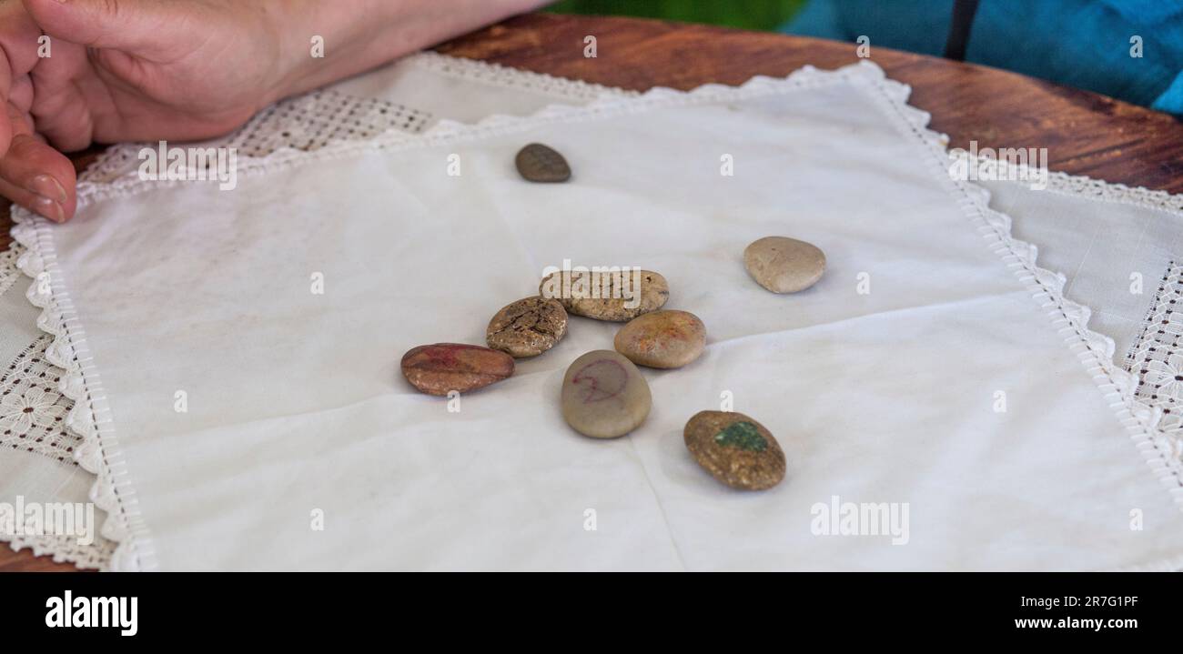 Fortune teller manipulating pebbles. Fortune telling in ancient rome ...