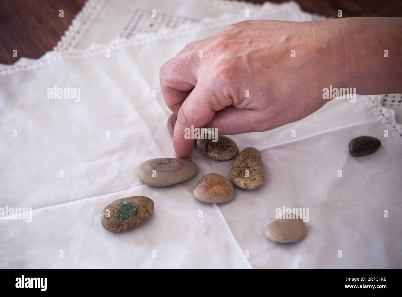 Fortune teller manipulating pebbles. Fortune telling in ancient rome ...