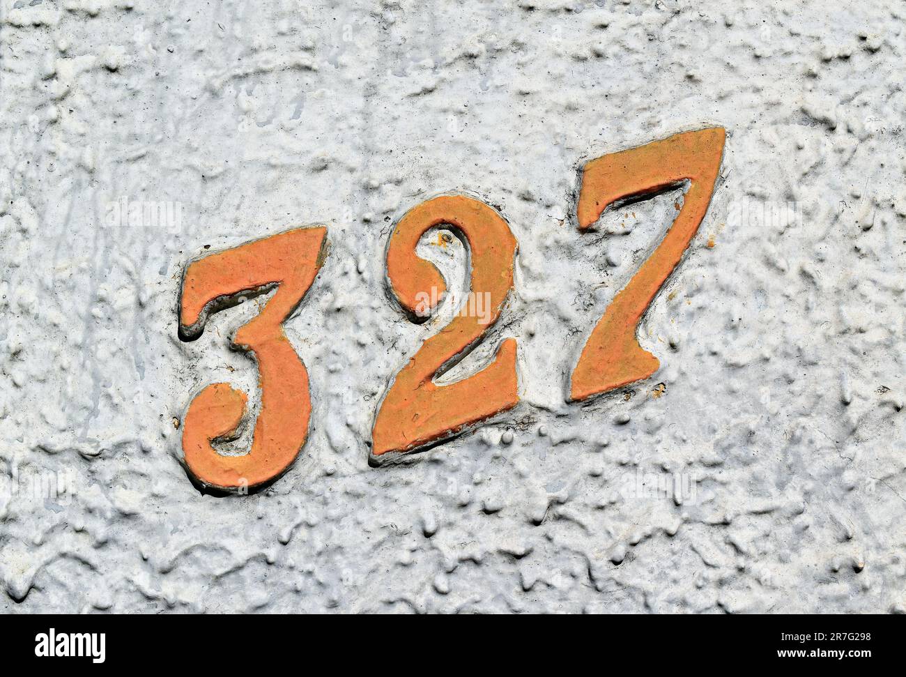 Street sign number 327 on a white wall Stock Photo - Alamy