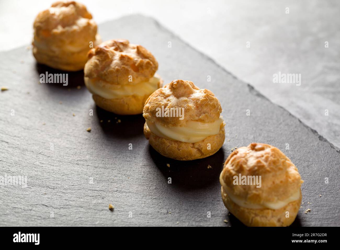 Custard-filled profiteroles ready to serve. The profiteroles are filled ...