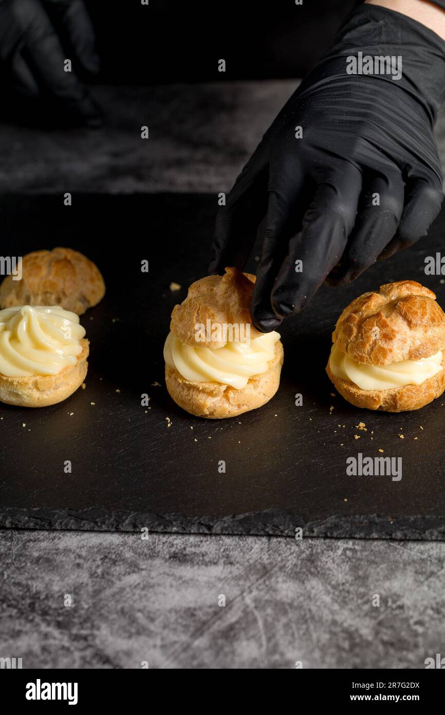 Custard-filled profiteroles ready to serve. The profiteroles are filled ...