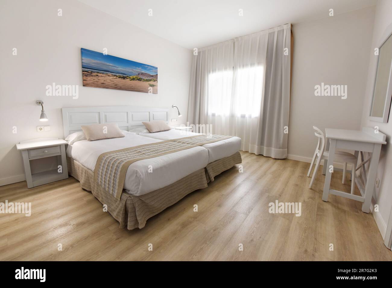 A modern and clean bedroom with single beds and other elegant details ...