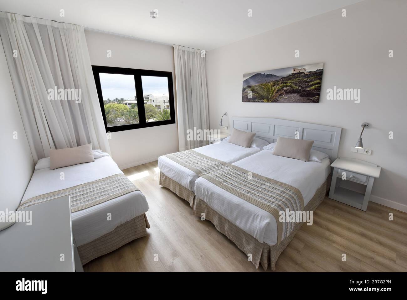 A modern and clean bedroom with single beds and other elegant details ...