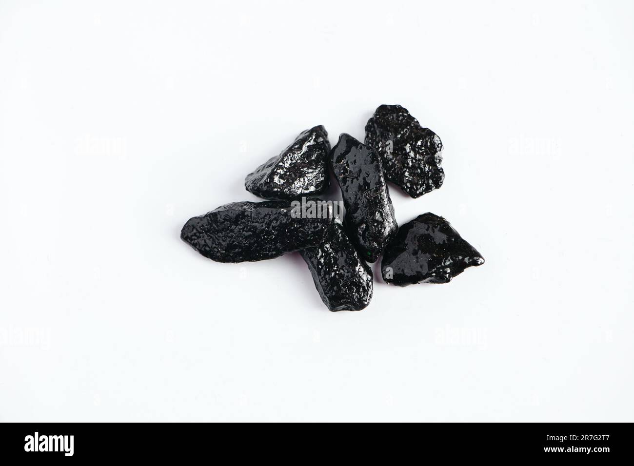Black shiny decorative stones on white background. Natural obsidian ...