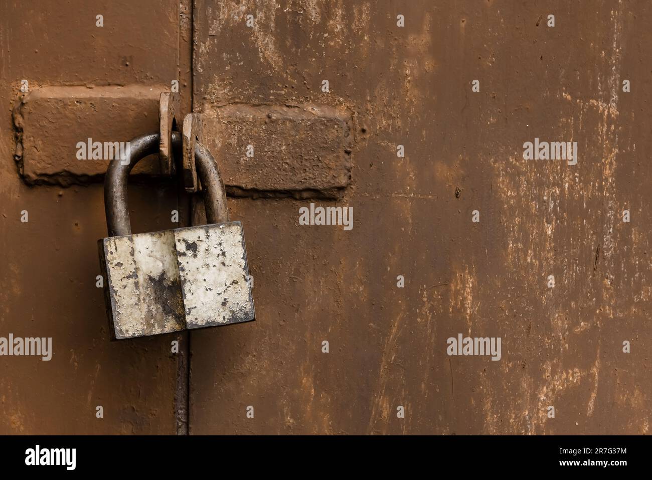 Old rusty lock on metal doors. Lock on the door with an empty place for ...