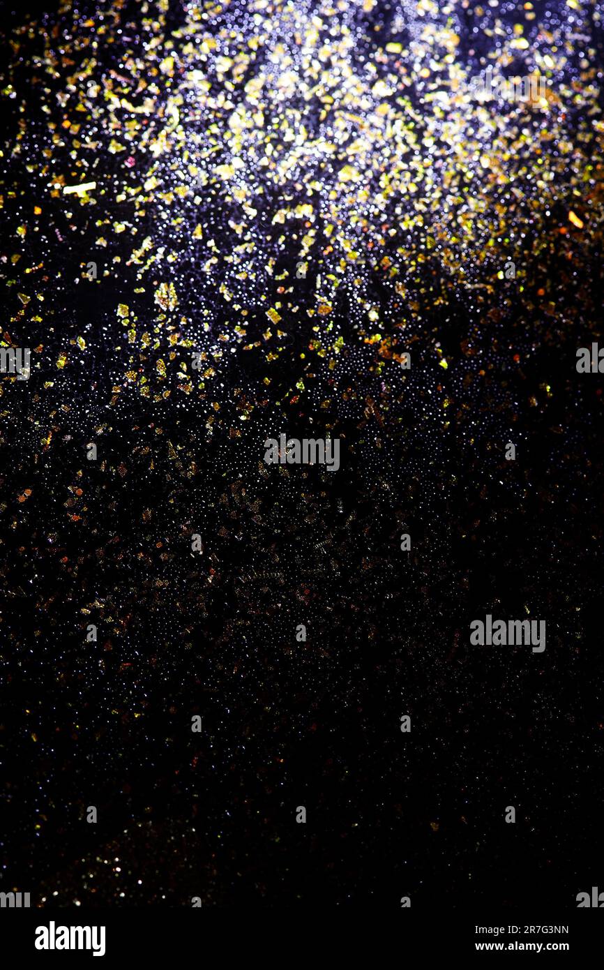 Blurred multicolor black background with glitter. Abstract space ...