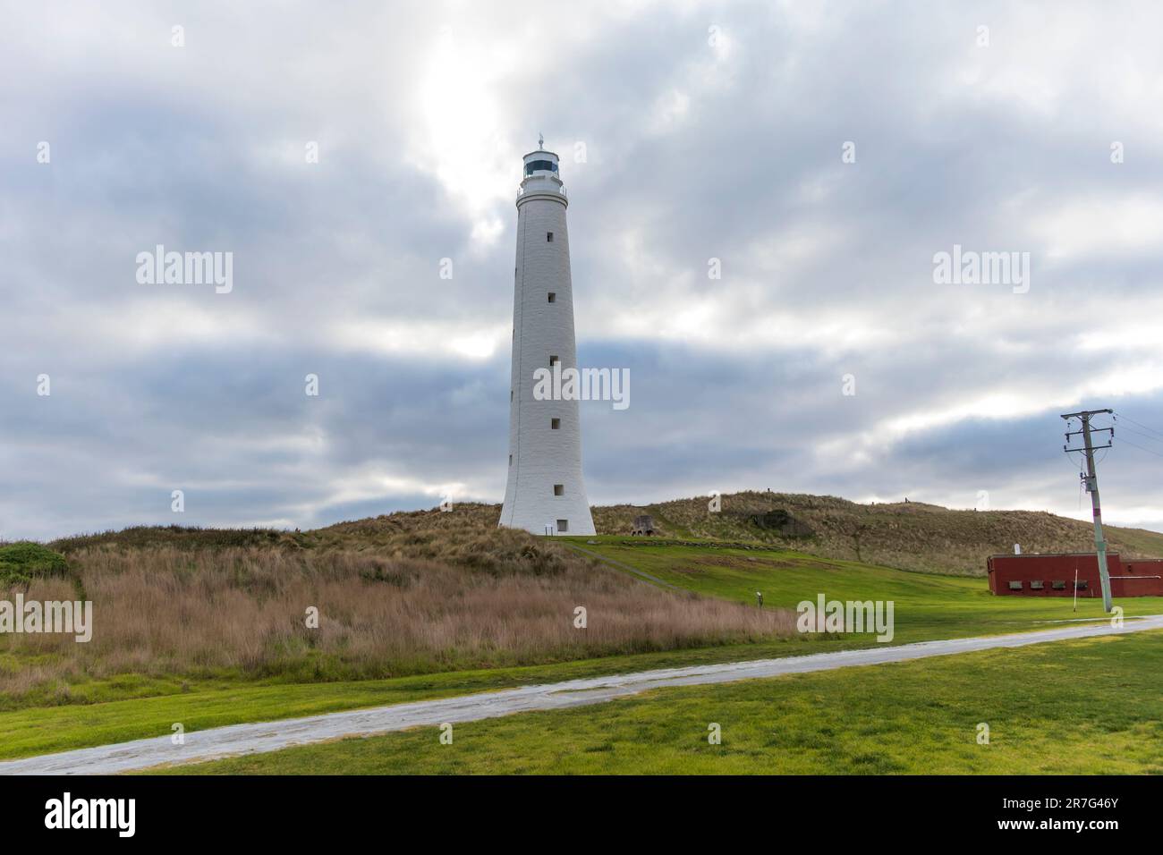 Photograph of Cape Wickham Lighthouse in a green field near Bass Strait ...