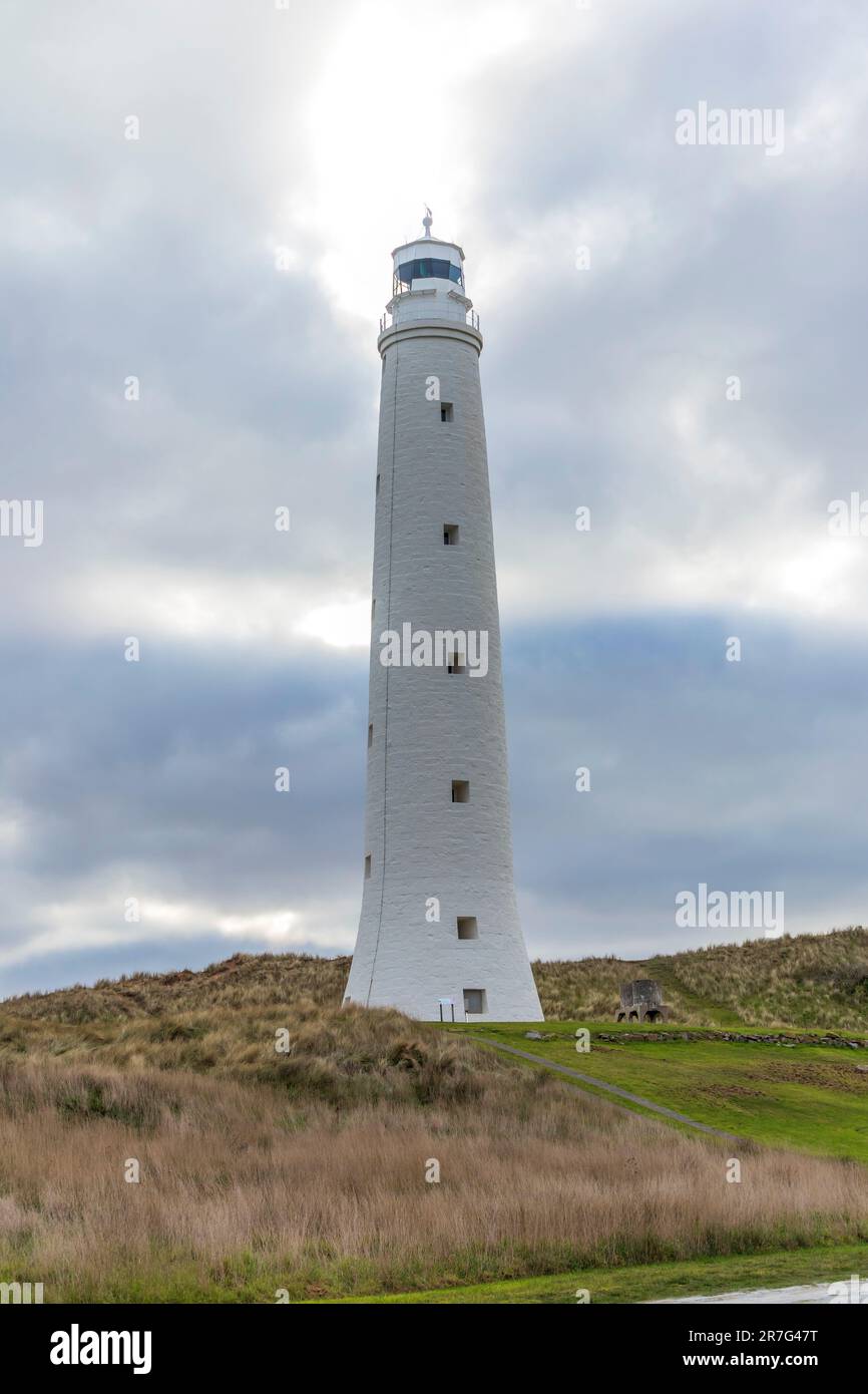Photograph of Cape Wickham Lighthouse in a green field near Bass Strait ...