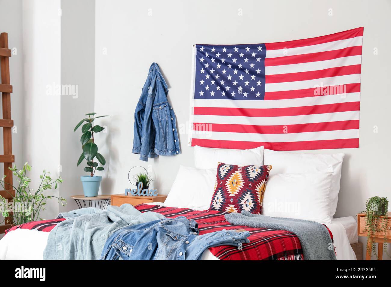 Interior of bedroom with USA flag and denim jackets Stock Photo - Alamy