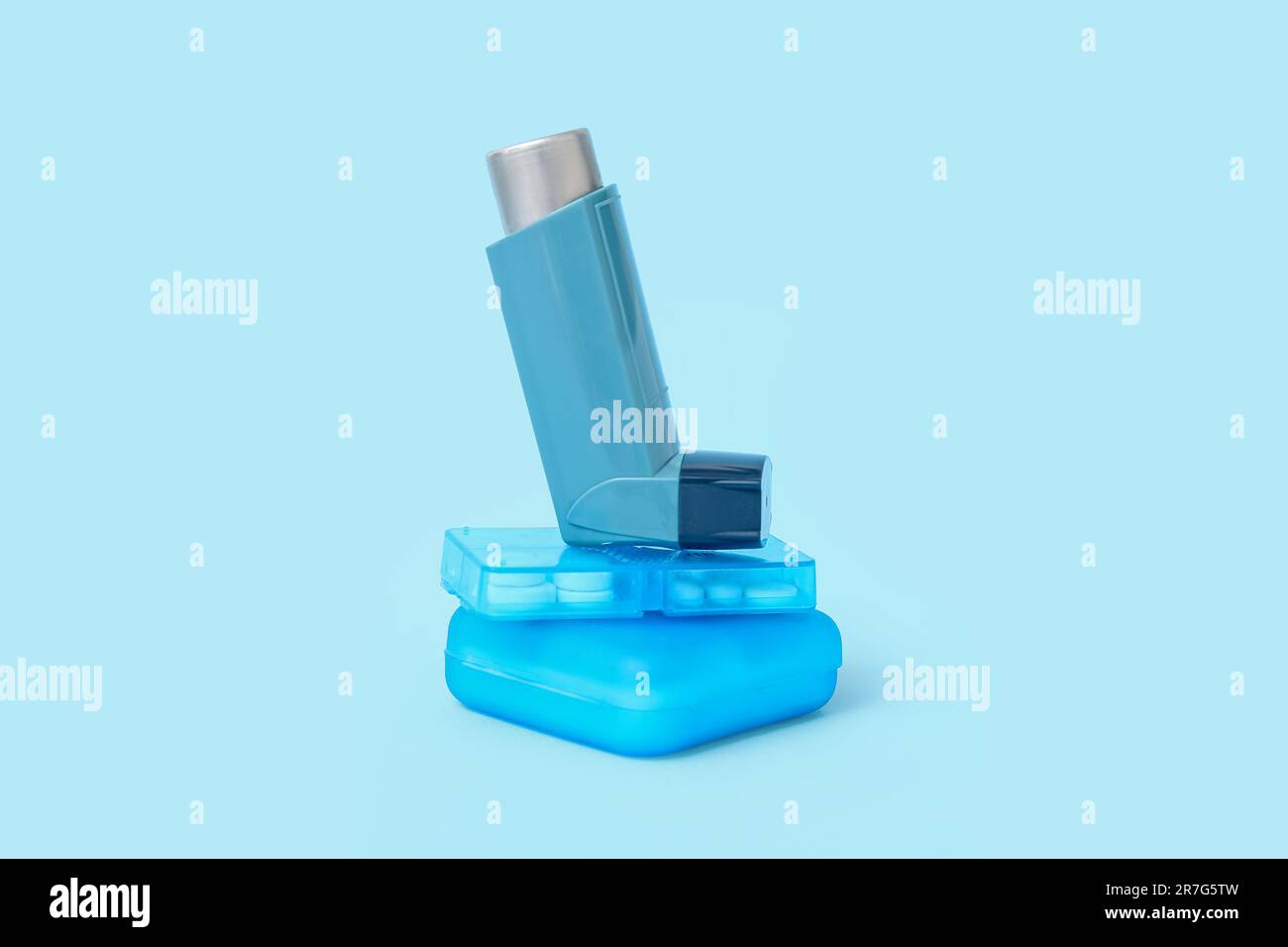 Asthma inhaler and boxes of pills on blue background Stock Photo - Alamy