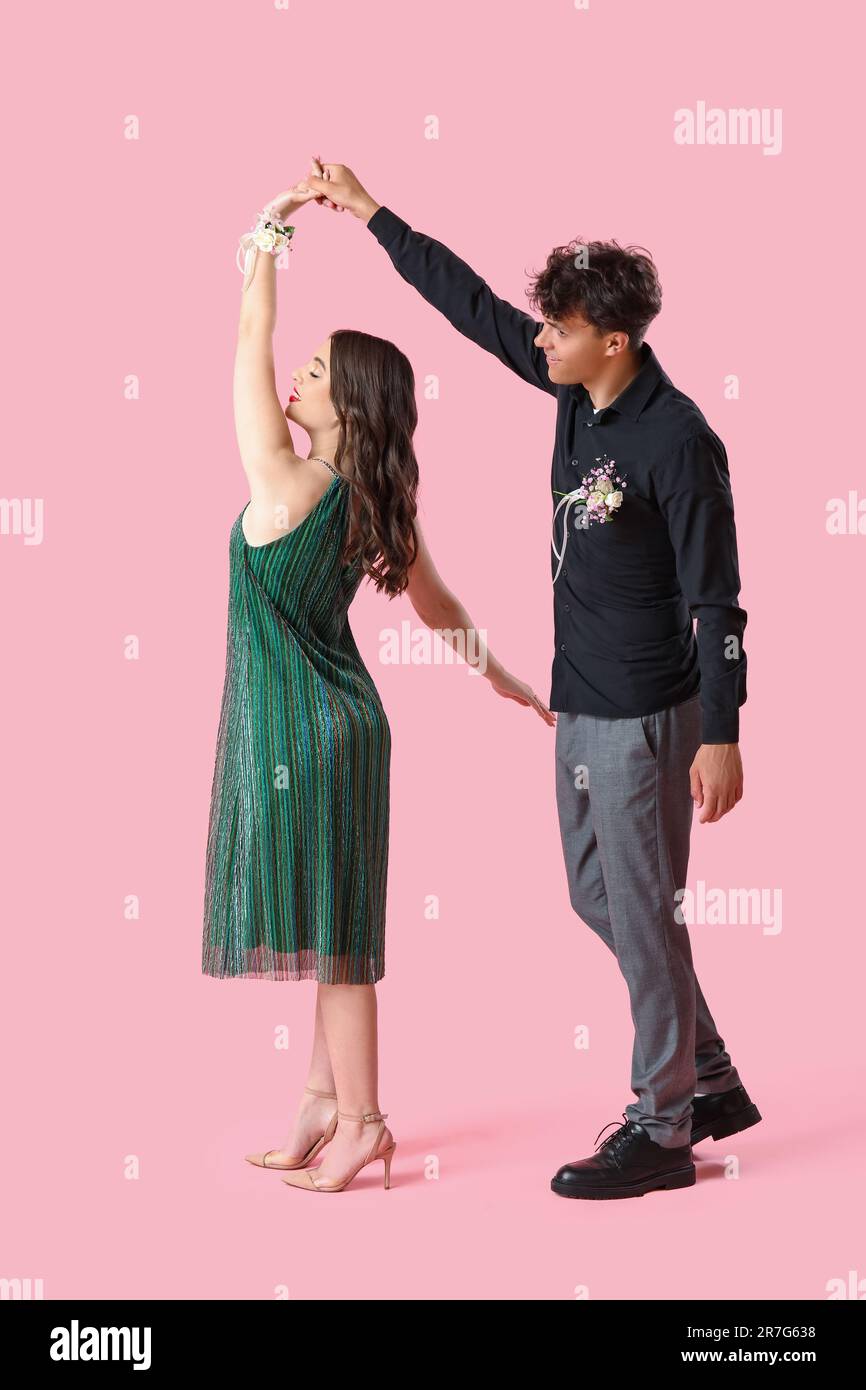 Beautiful prom couple dancing on pink background Stock Photo - Alamy