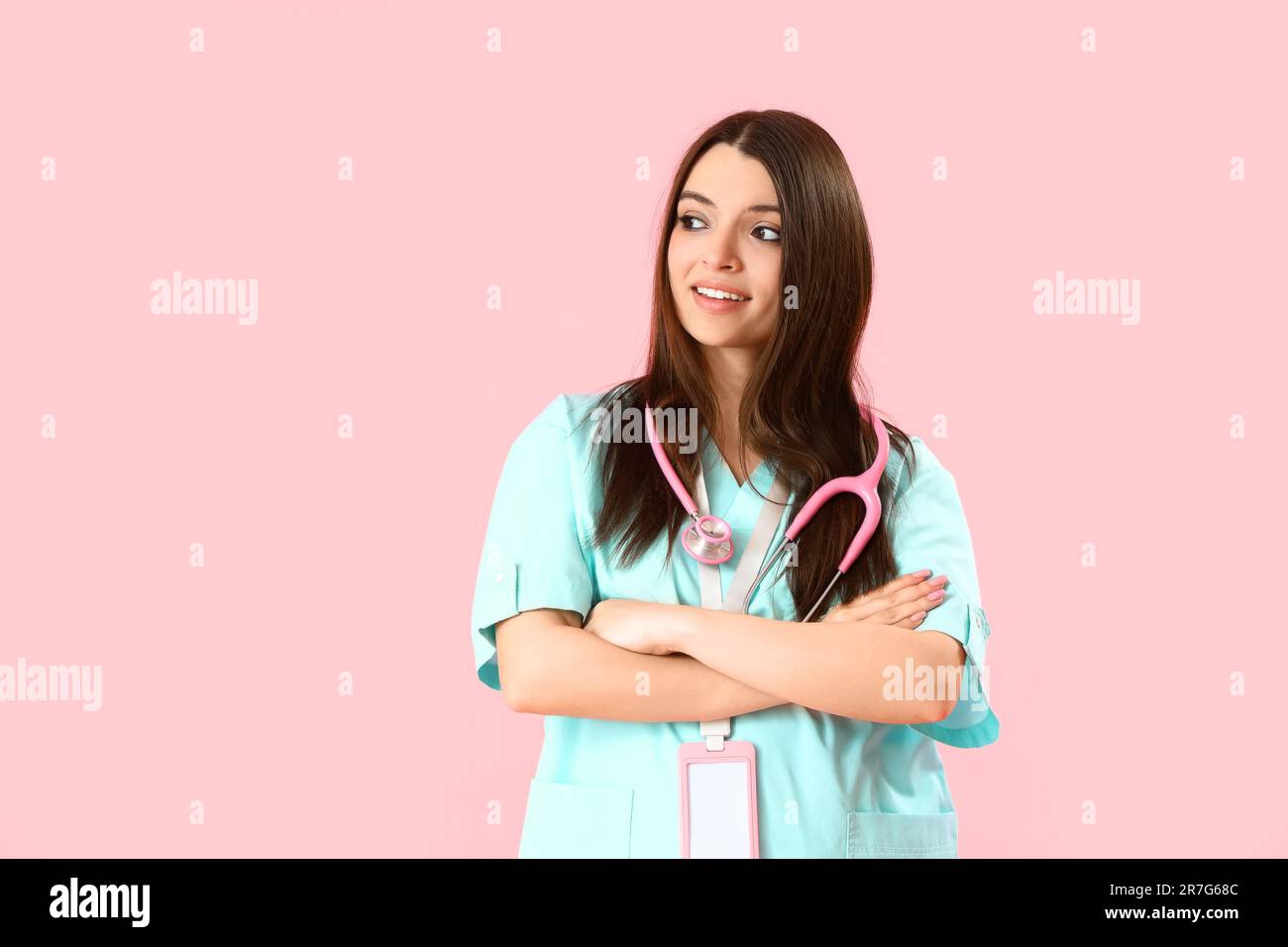 Female medical intern with stethoscope on pink background Stock Photo ...