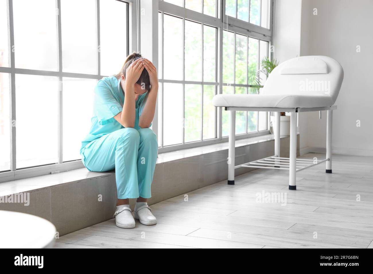 Stressed female medical intern at hospital Stock Photo - Alamy
